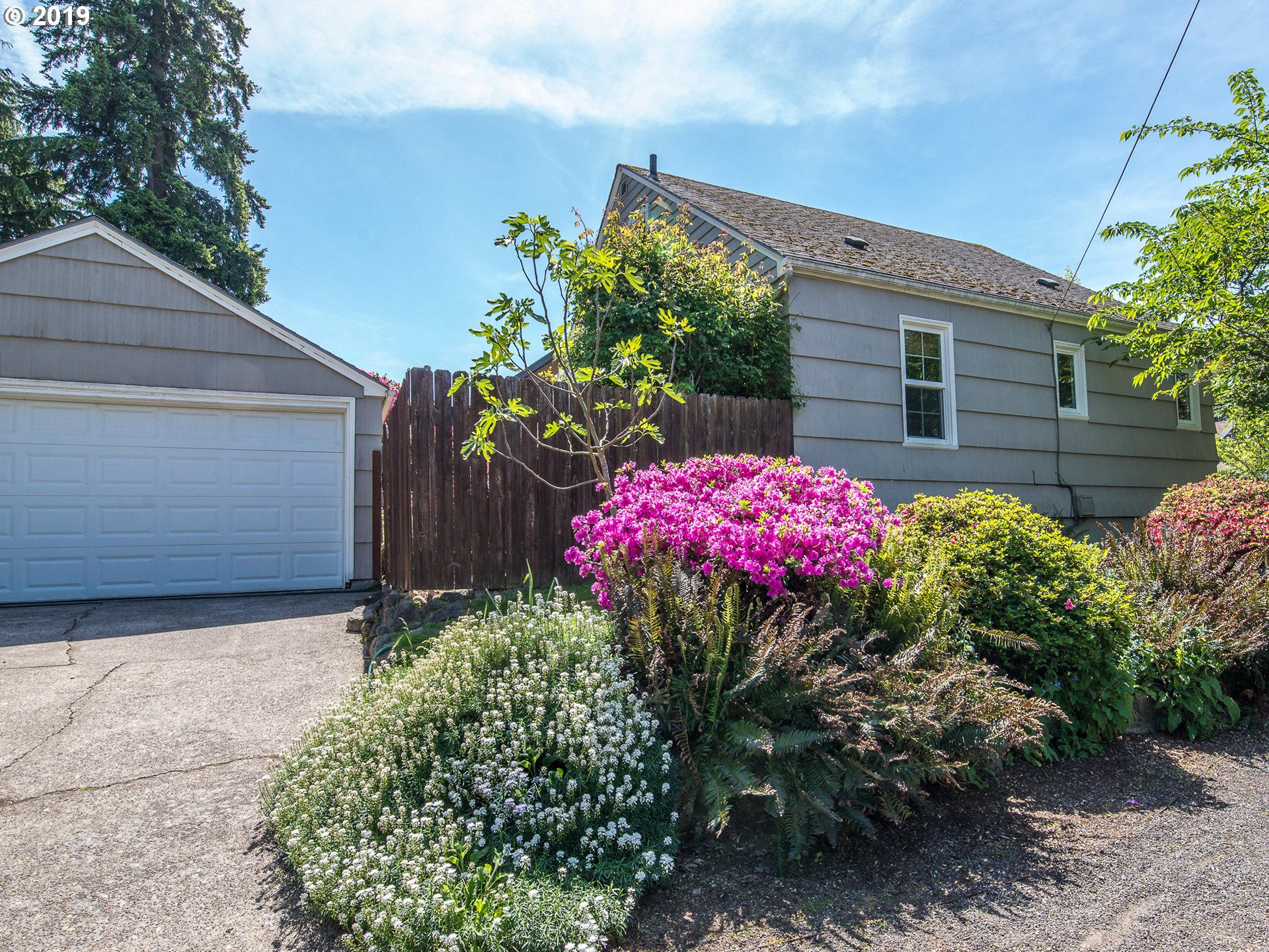 Garden Hideaway Loaded with Versatility! - Living Room Realty